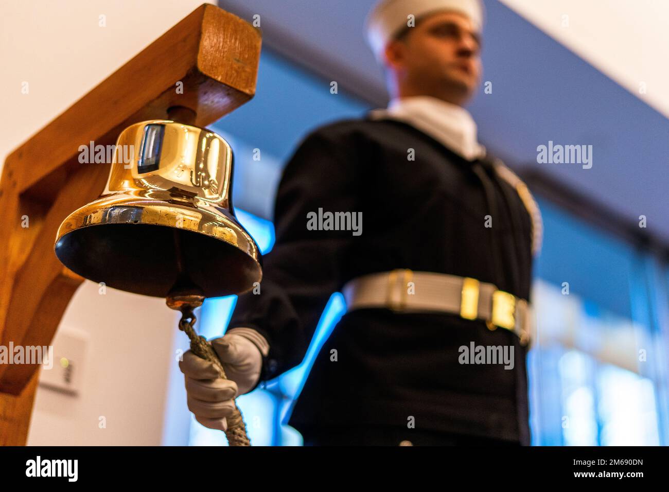 A bell is rung during the departure of the official party during a ...