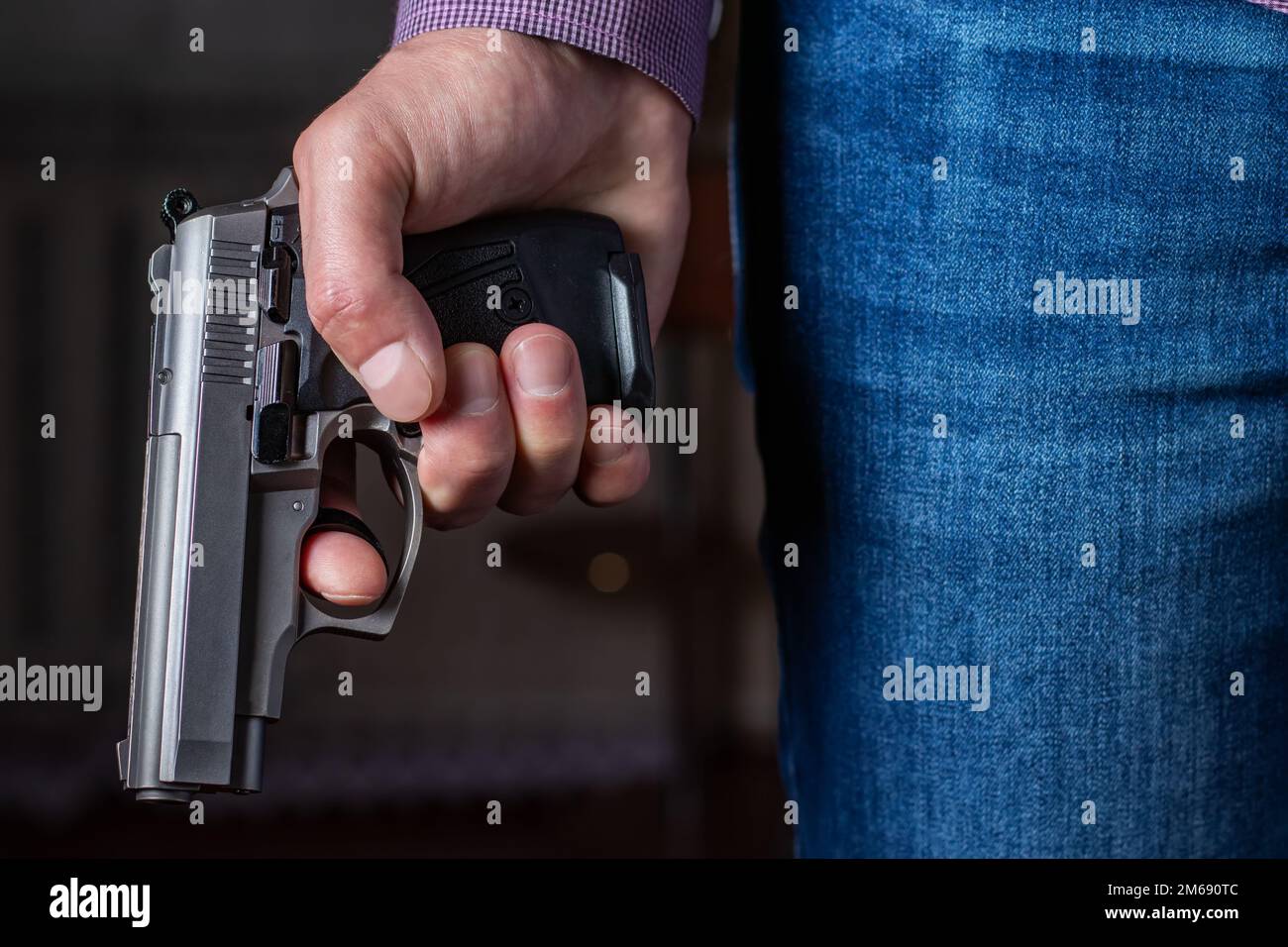 Gun control concept. Armed man holds pistol in hand Stock Photo - Alamy
