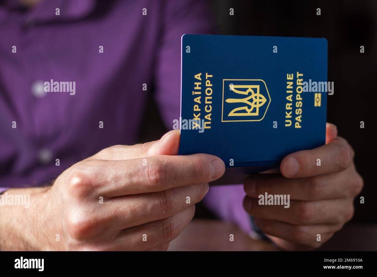 New ukrainian blue biometric passport with identification chip in hands ...