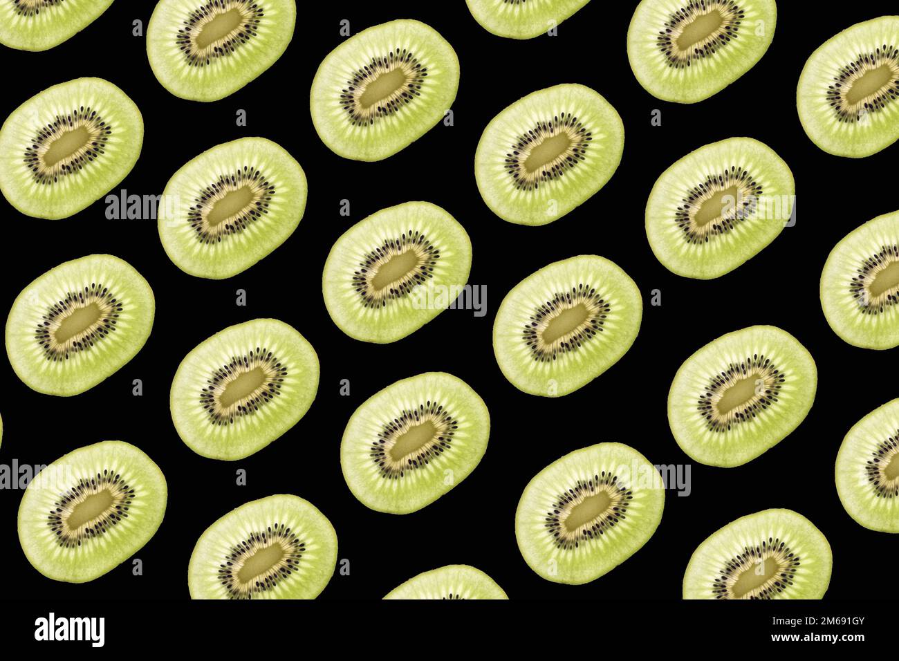 Pattern made of backlit kiwi fruit slices on black background Stock ...