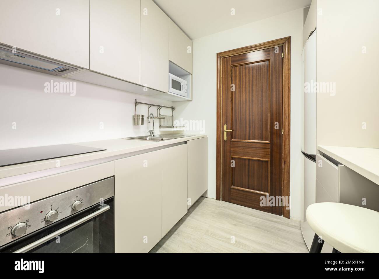 Newly installed kitchen with smooth white cabinets without handles ...