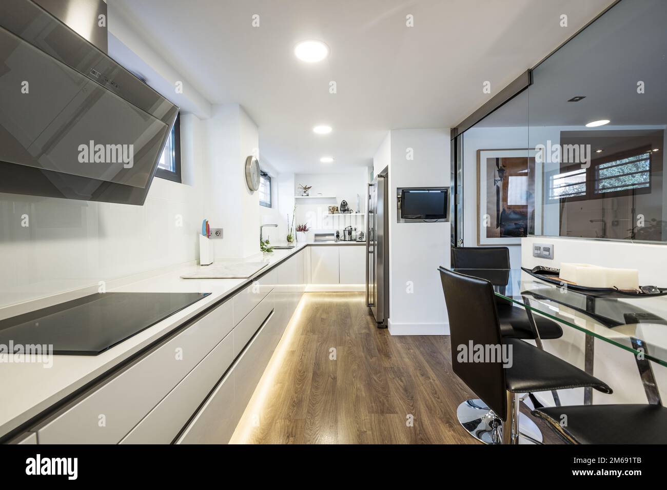 Elongated modern conventional kitchen with handleless cabinets with ...