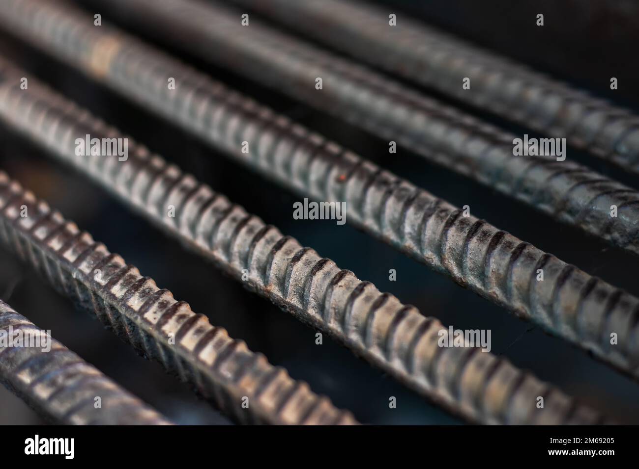 Stack of heavy metal reinforcement bars with periodic profile texture ...