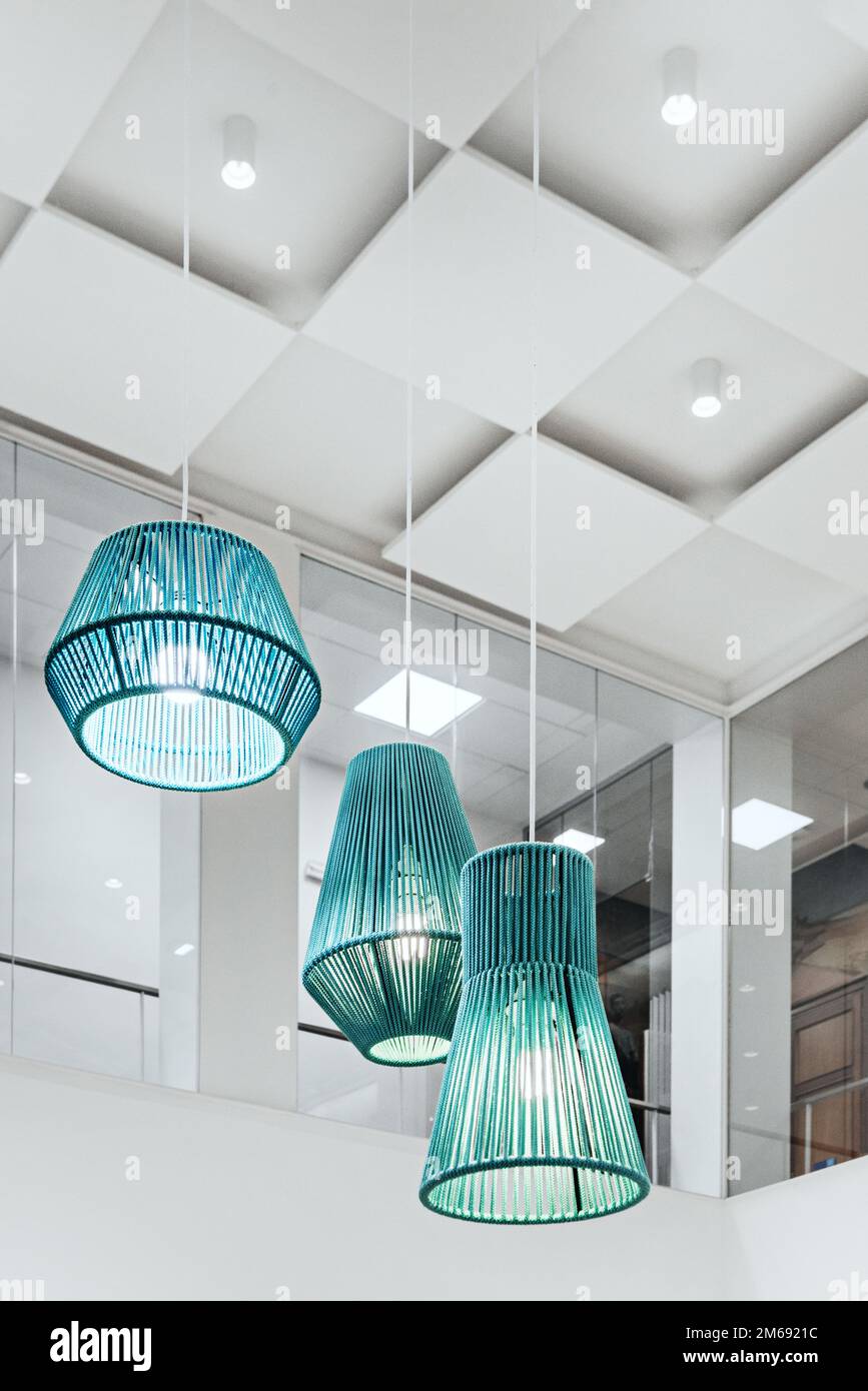 Decorative blue rope lamps in an office with plasterboard decoration on ...