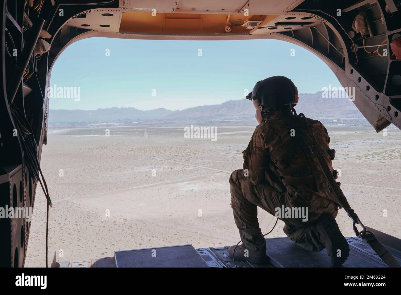 A U.S. Army crew chief, assigned to the 1st Armored Division, sits on ...