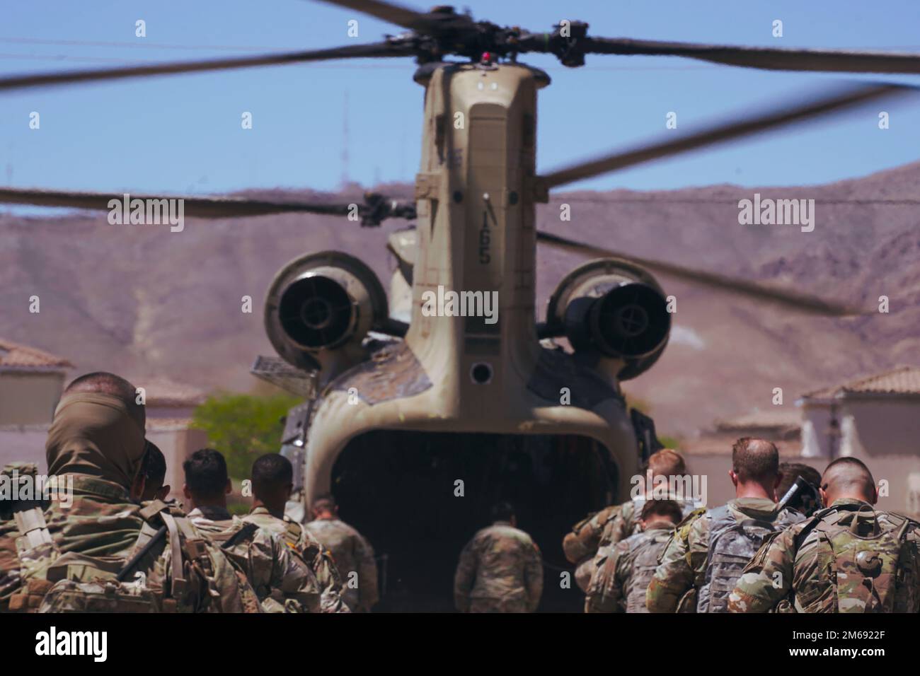 U.S. Soldiers, assigned to the 1st Armored Division, board the chinook ...