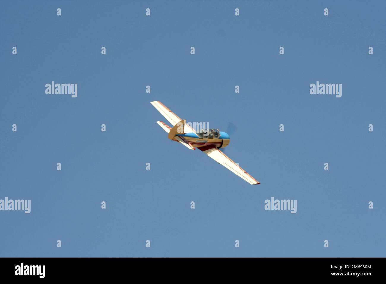Propeller-driven airplane on clear sky background Stock Photo - Alamy