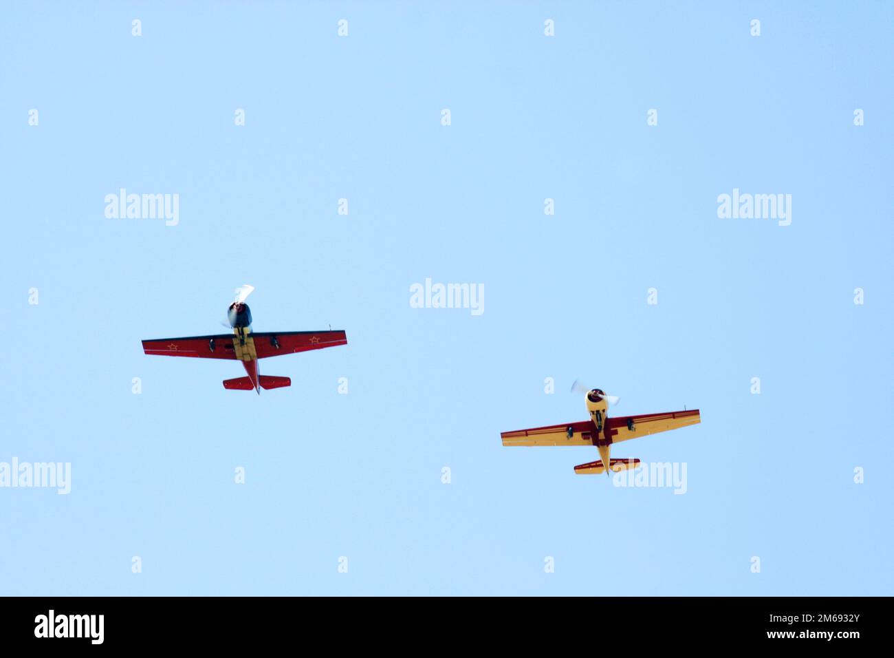 Two propeller-driven airplanes on clear sky background Stock Photo - Alamy