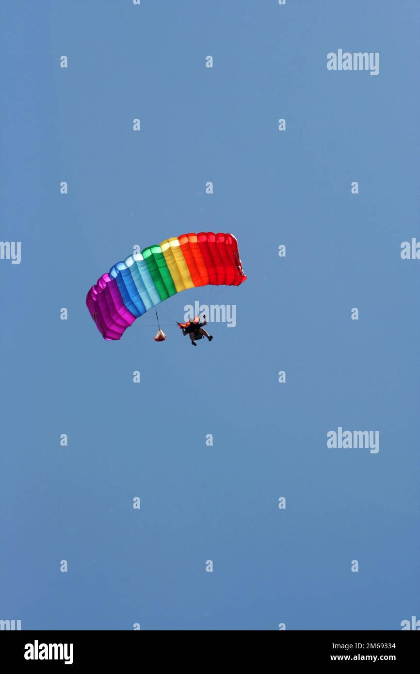 Parachuter with colored parachute on sky background 3 Stock Photo - Alamy