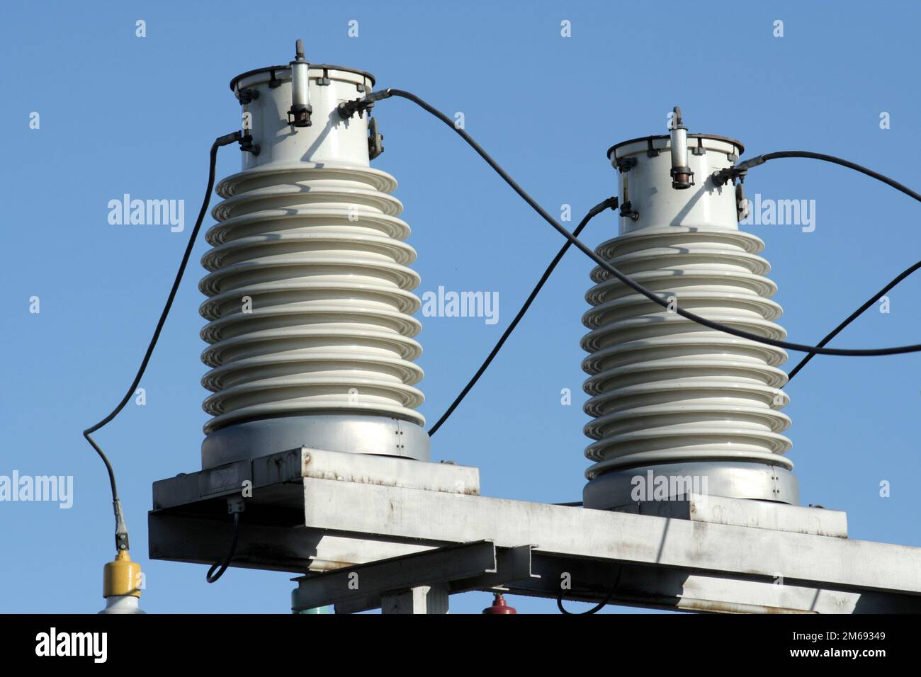 Two big insulators on the high-voltage substation Stock Photo - Alamy