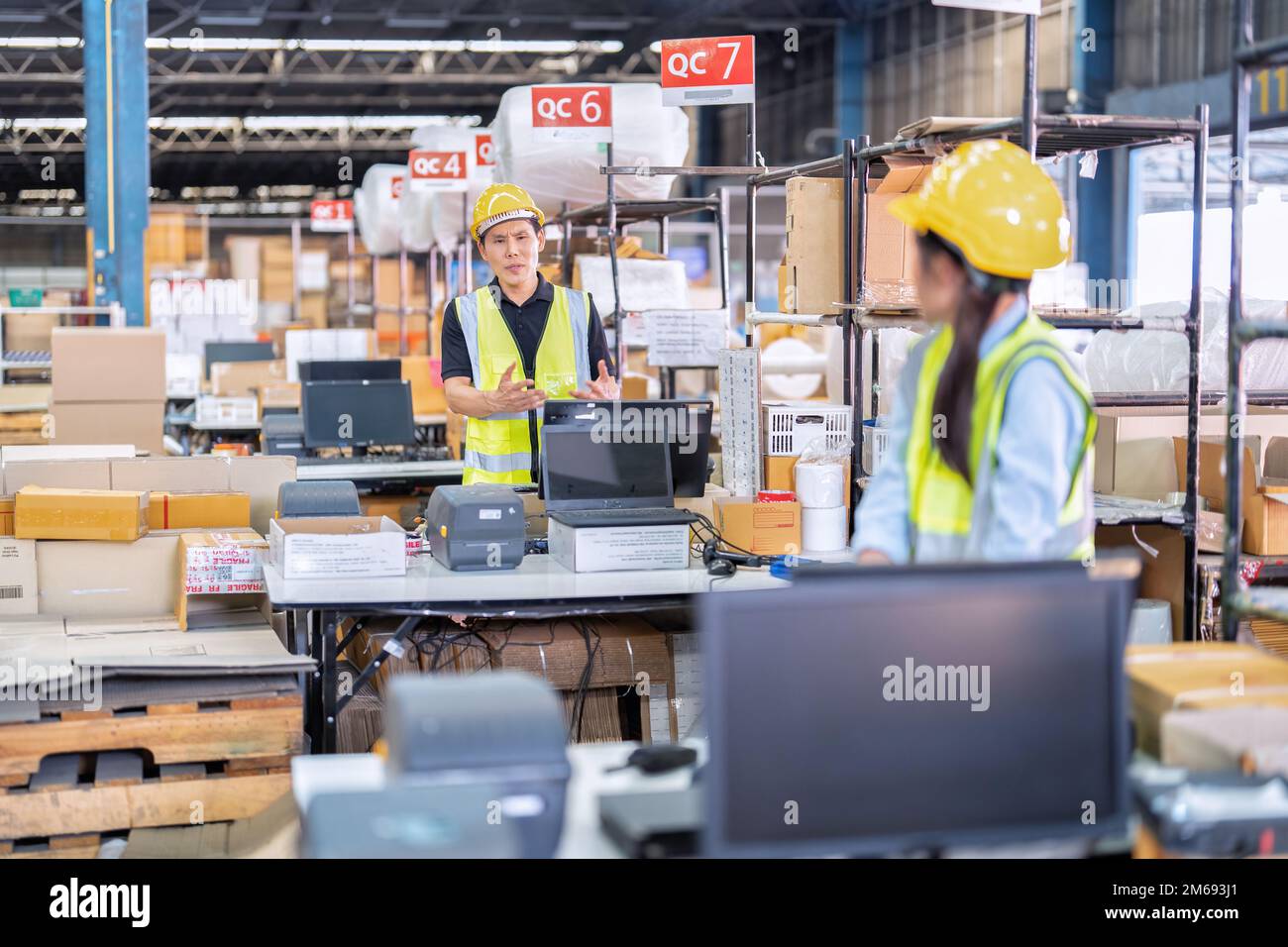 Worker working in the large depot storage warehouse concentrate check ...