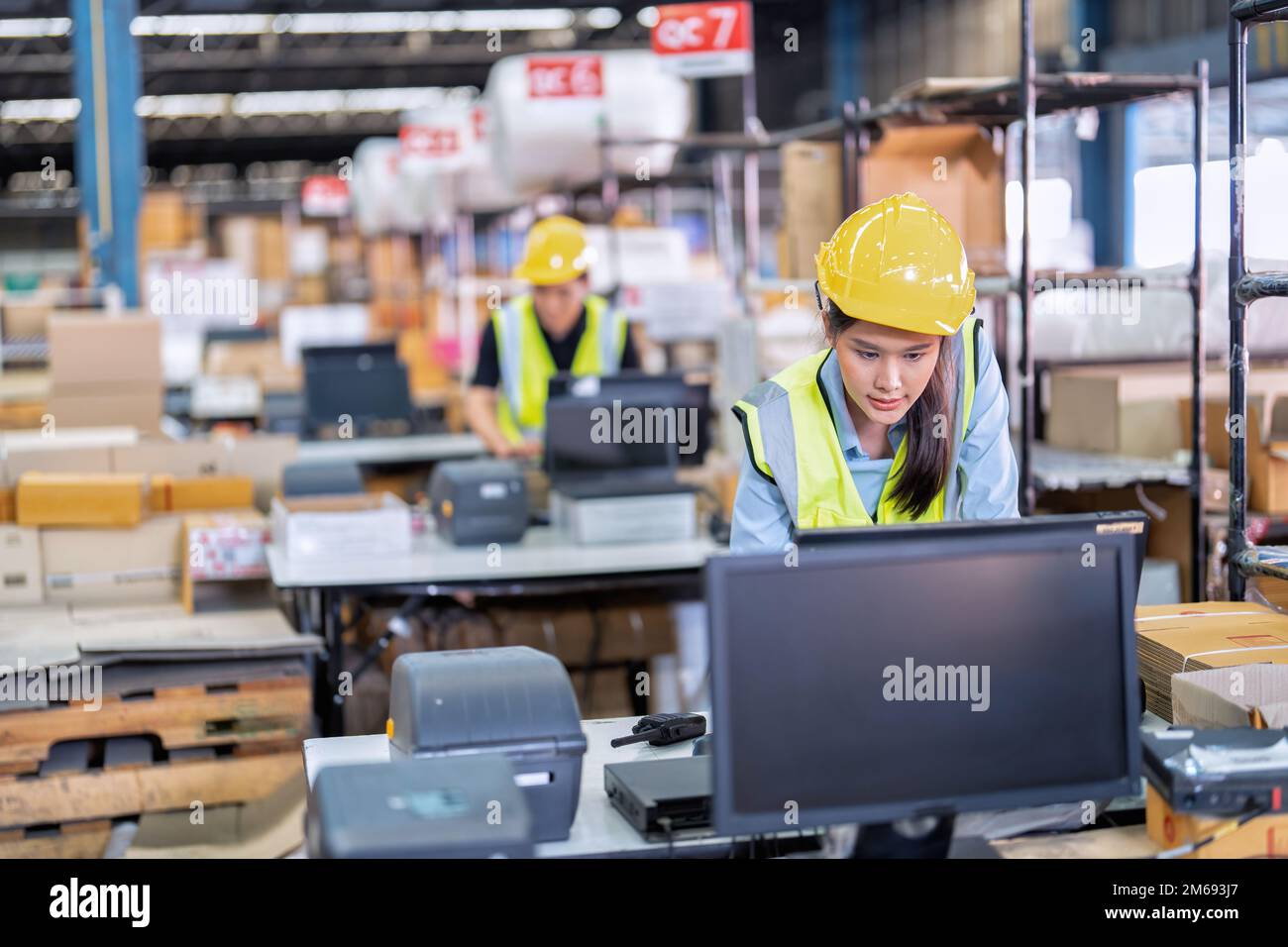 Worker working in the large depot storage warehouse concentrate check ...