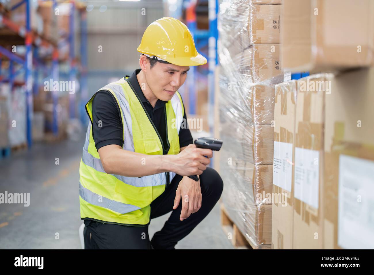 Staff working in large depot storage warehouse hold wireless barcode ...