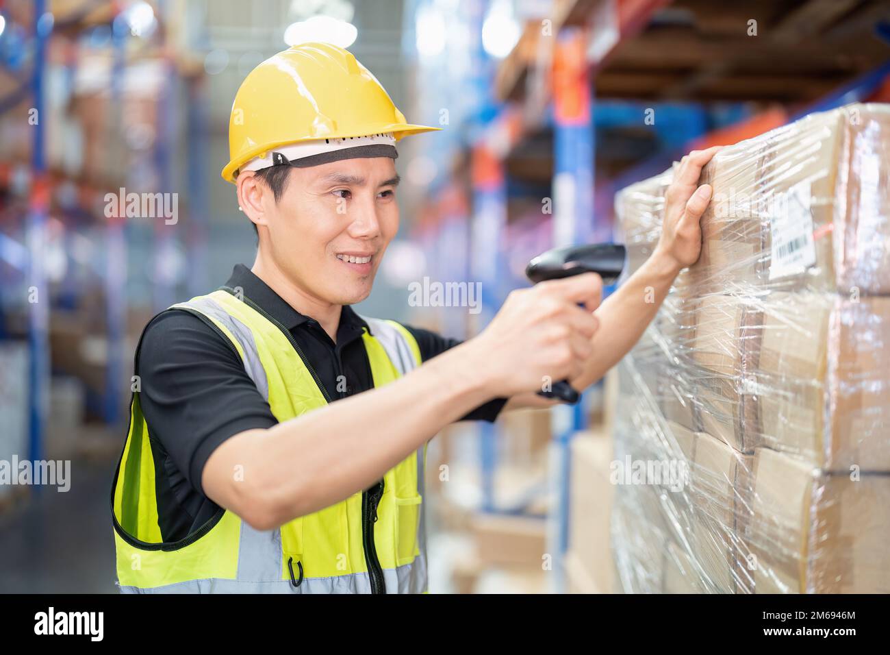 Staff working in large depot storage warehouse hold wireless barcode ...