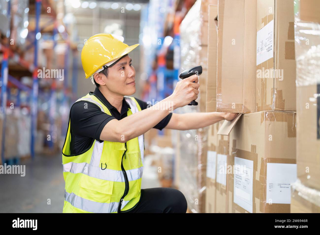 Staff working in large depot storage warehouse hold wireless barcode ...