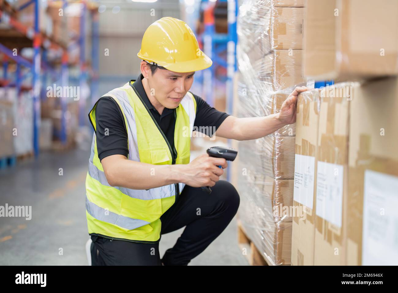 Staff working in large depot storage warehouse hold wireless barcode ...