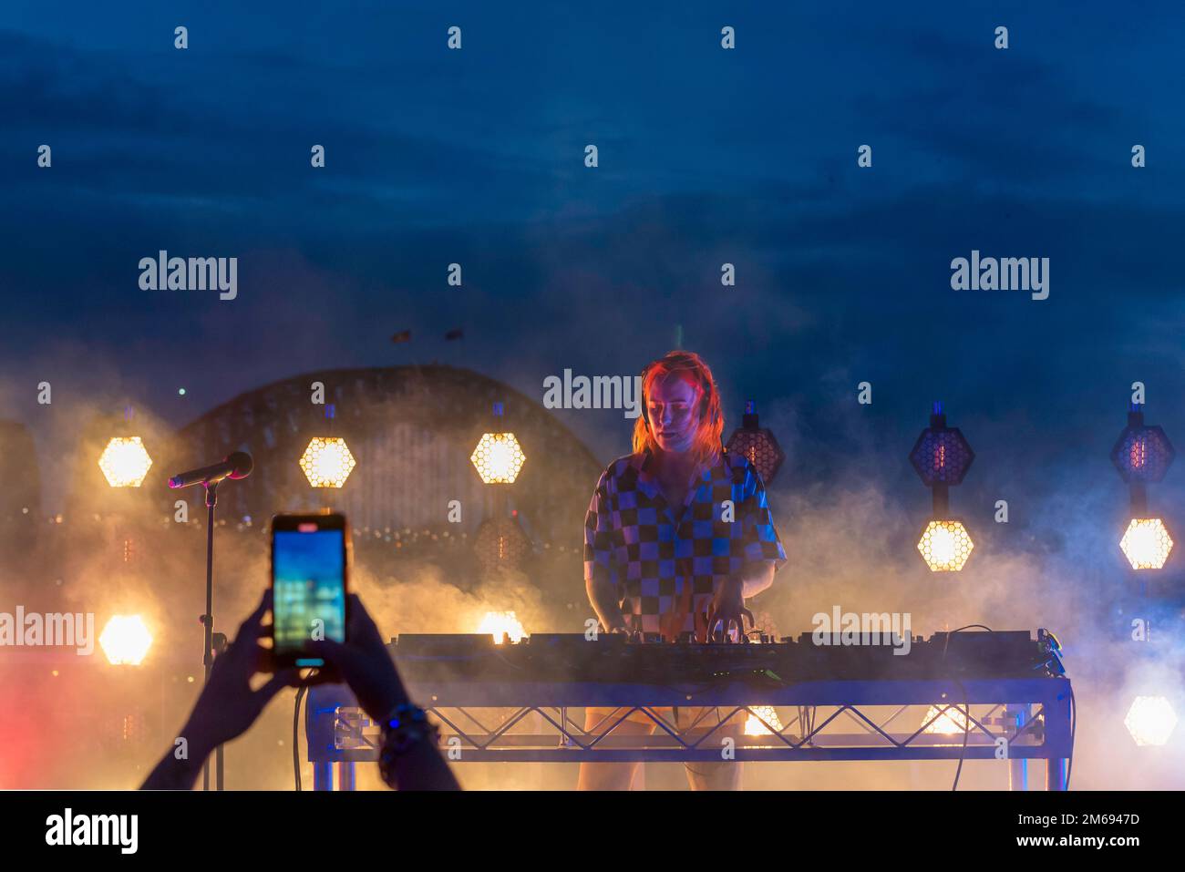 Dj plays with sydney harbour bridge in background hi-res stock ...