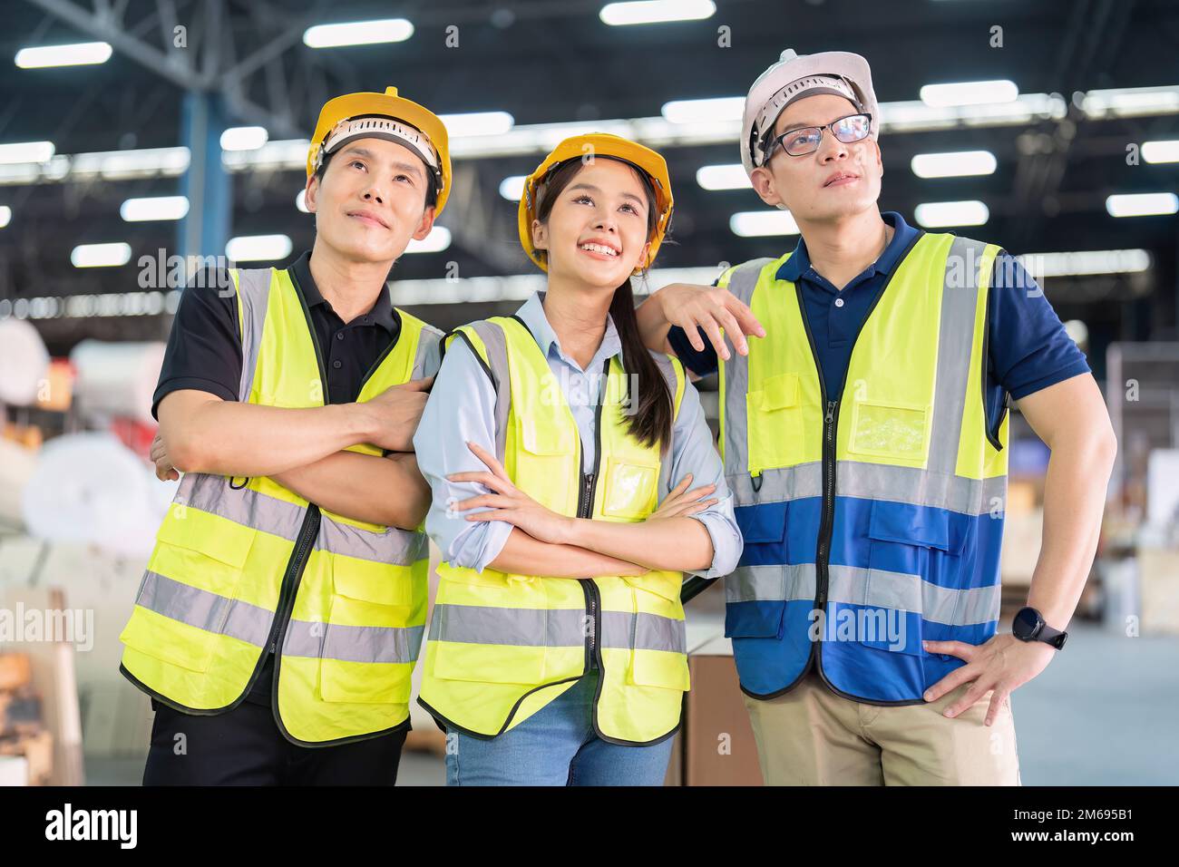 Staff in large storage warehouse together portrait after work completed ...
