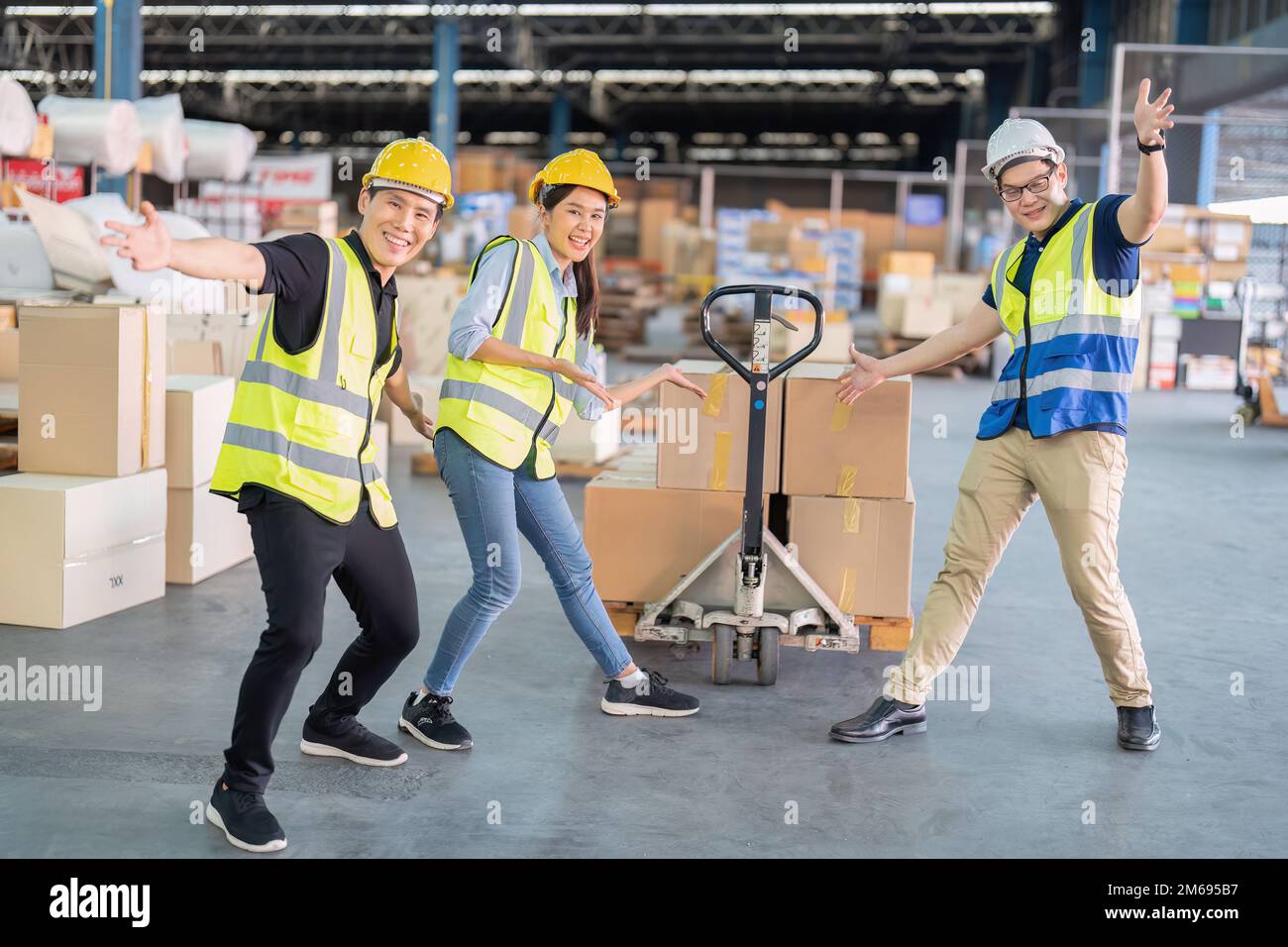 Staff in large storage warehouse together portrait after work completed ...