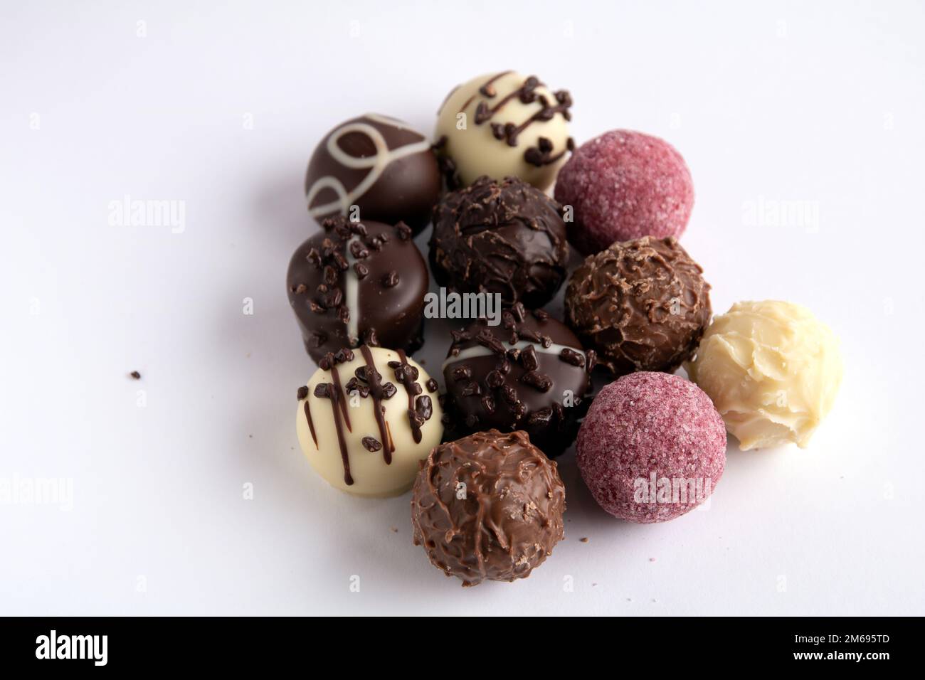 photo different chocolates lying next to each other on a white ...