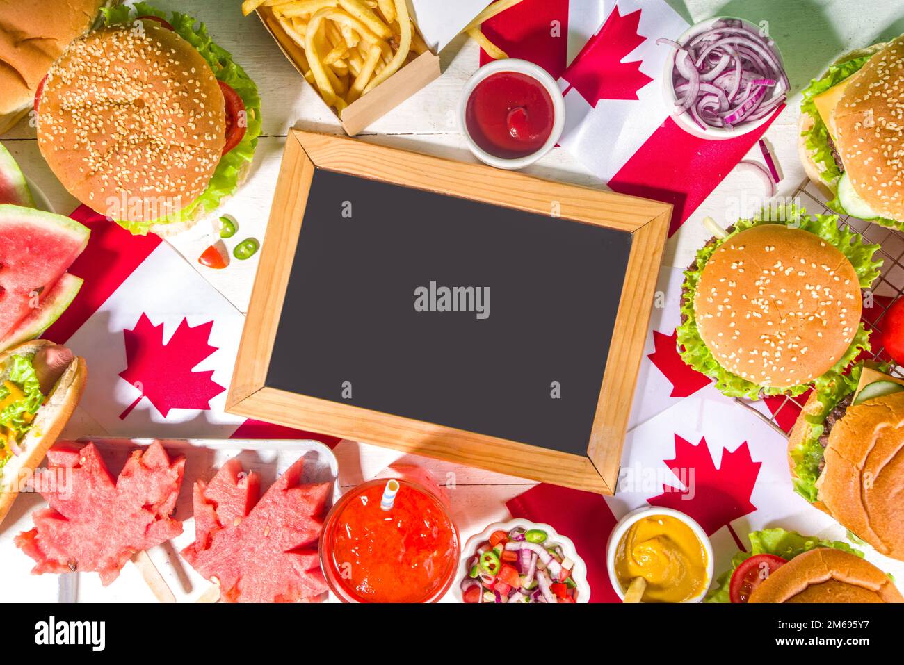 Set of various Canada Day bbq food. Picnic party table with maple leaf ...
