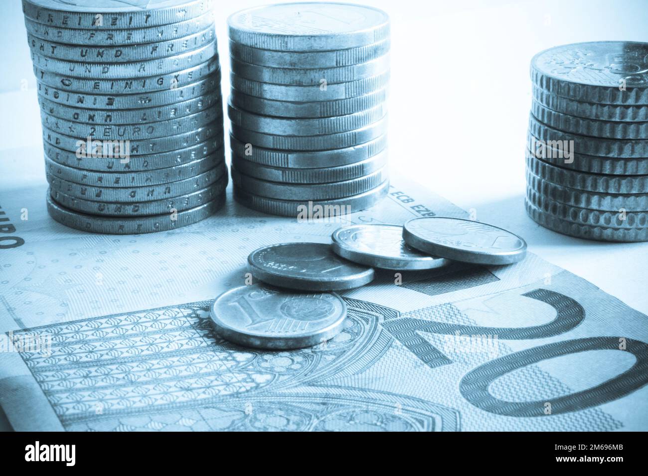 3 piles of money and bank note Stock Photo - Alamy