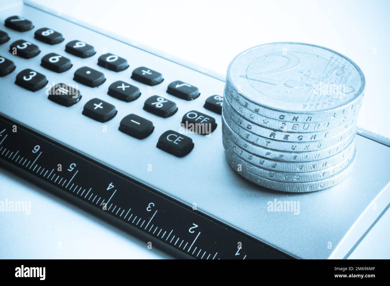Pocket calculator and coin stack Stock Photo - Alamy