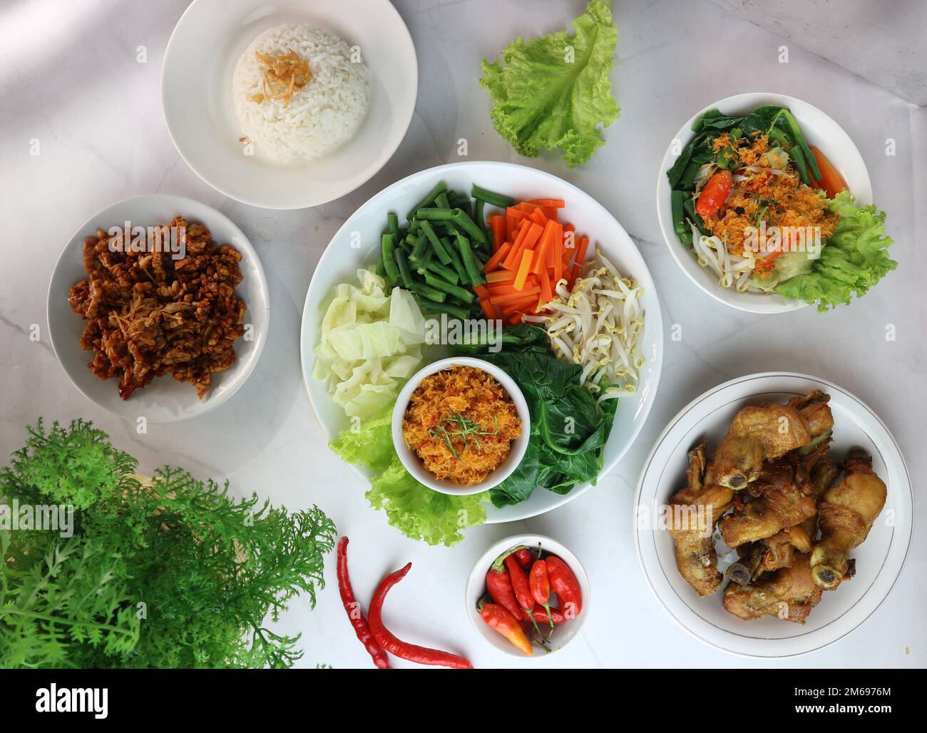 a variety of Indonesian traditional food served on white plates Stock ...