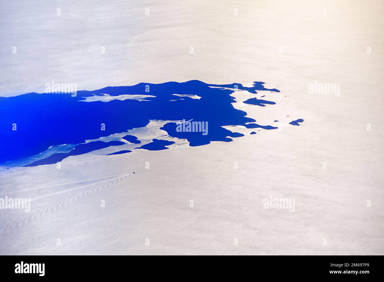 Blue islands view from above . Flying over the islets . White sea blue ...