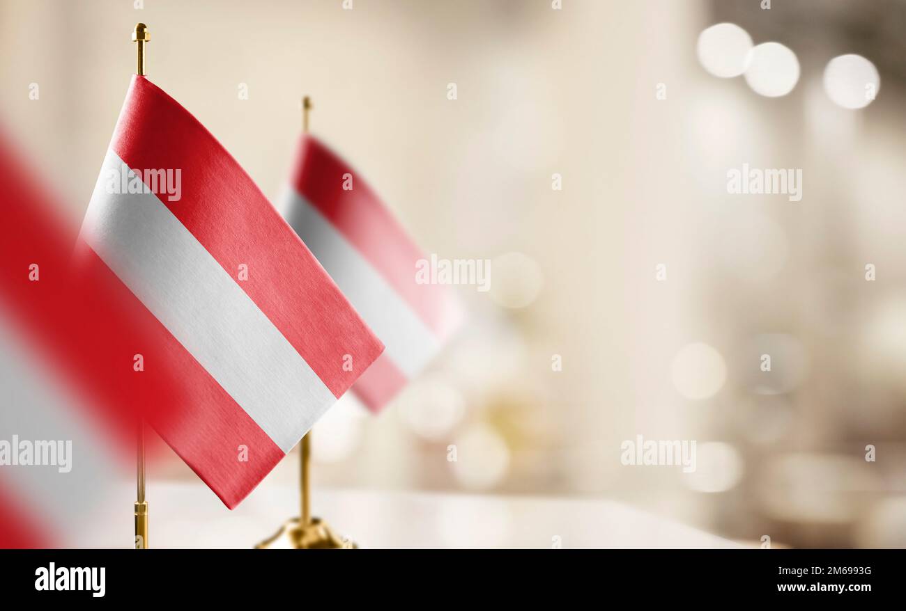 Small flags of the Austria on an abstract blurry background Stock Photo ...