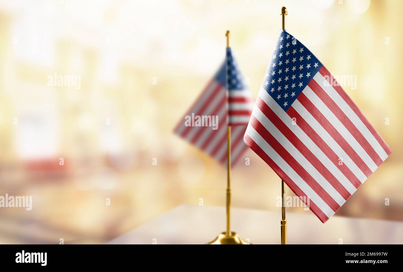 Small flags of the USA on an abstract blurry background Stock Photo - Alamy