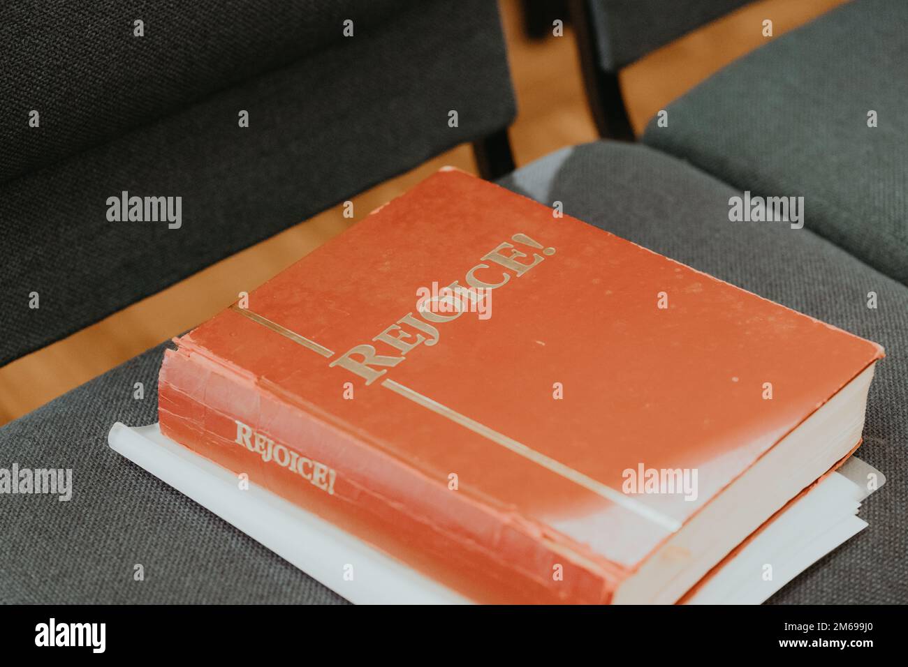 A book with name' rejoice' on chair Stock Photo - Alamy