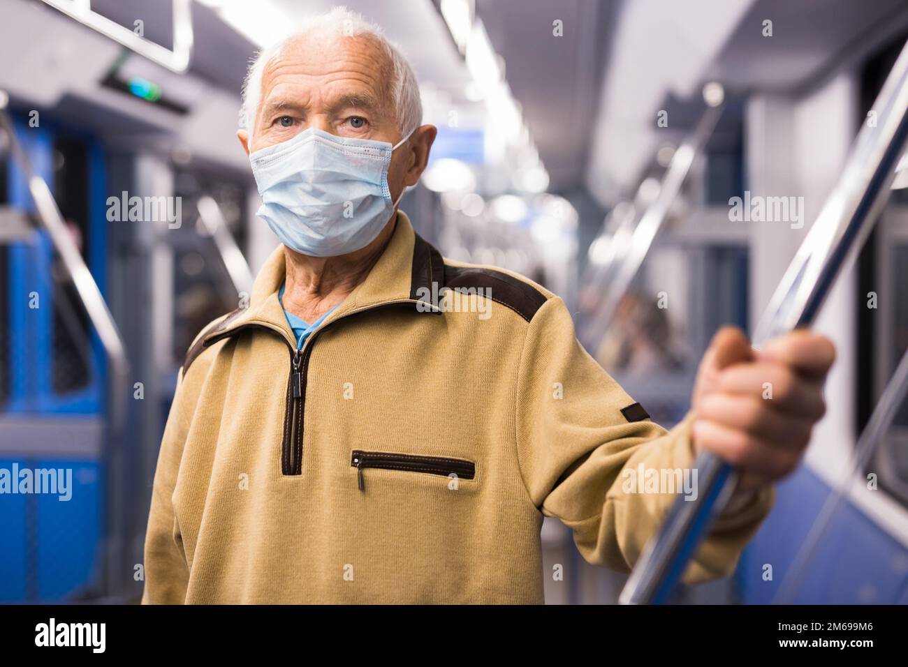 Senior man in mask inside subway car Stock Photo - Alamy
