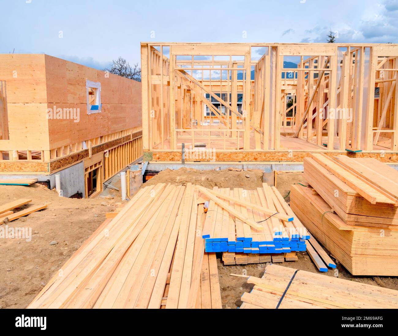 Wooden frame of new building with engineered lumber materials in front ...