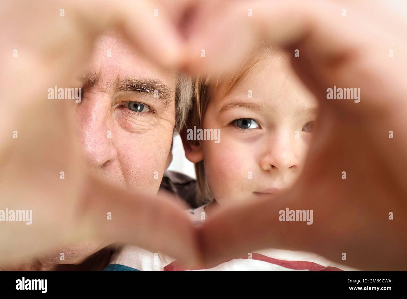 Grandfather and Grandson Making a Heart Shape Hand Gesture Together ...