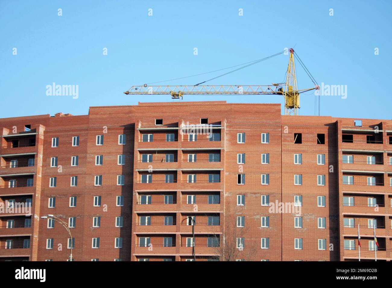 Lifting crane on building of the new house on sky background Stock ...