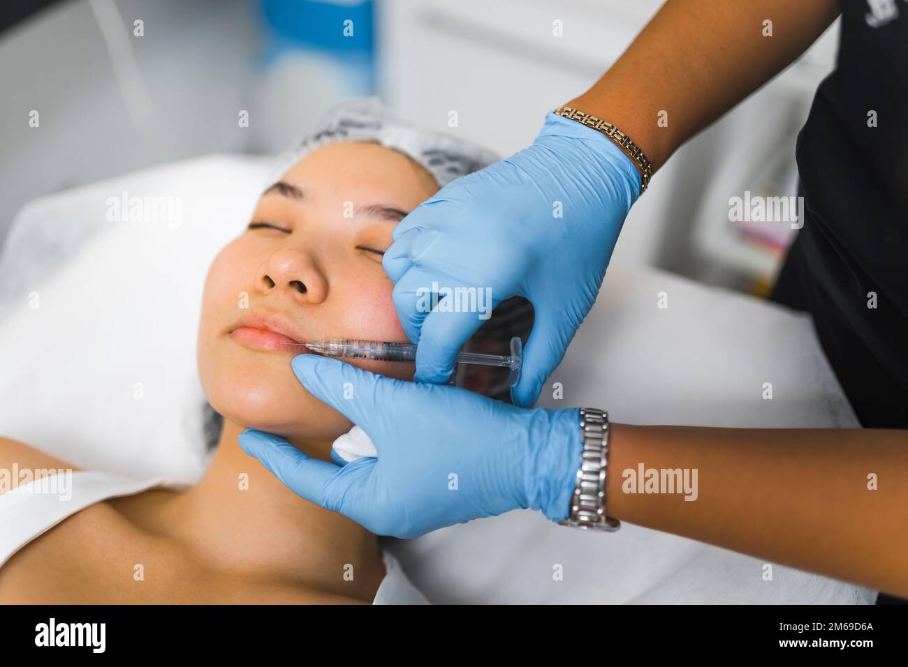 A close-up shot of a woman getting a lip filler collagen injection ...