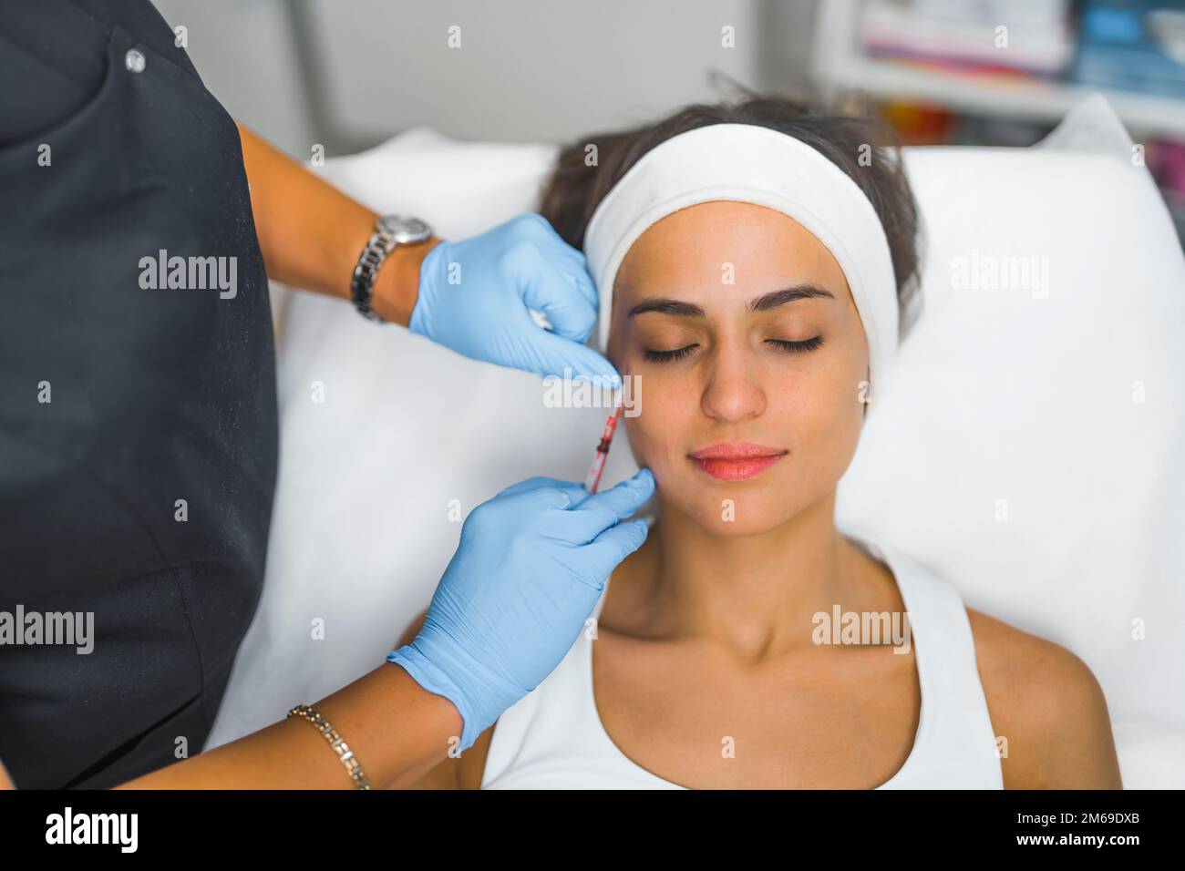 A woman receiving a collagen injection. High-angle shot. Aesthetic ...
