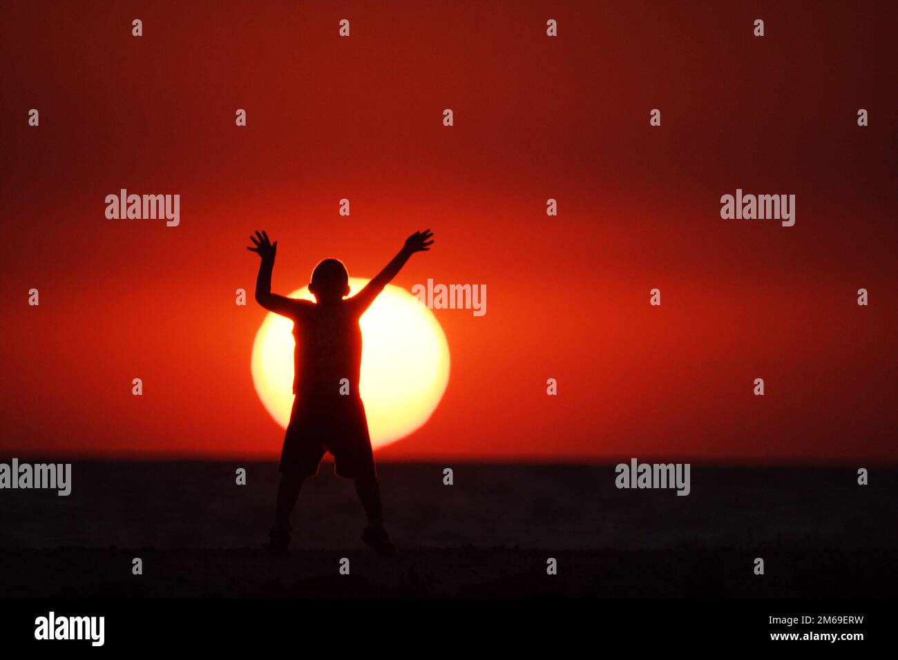 Big Sun and Boy Stock Photo - Alamy