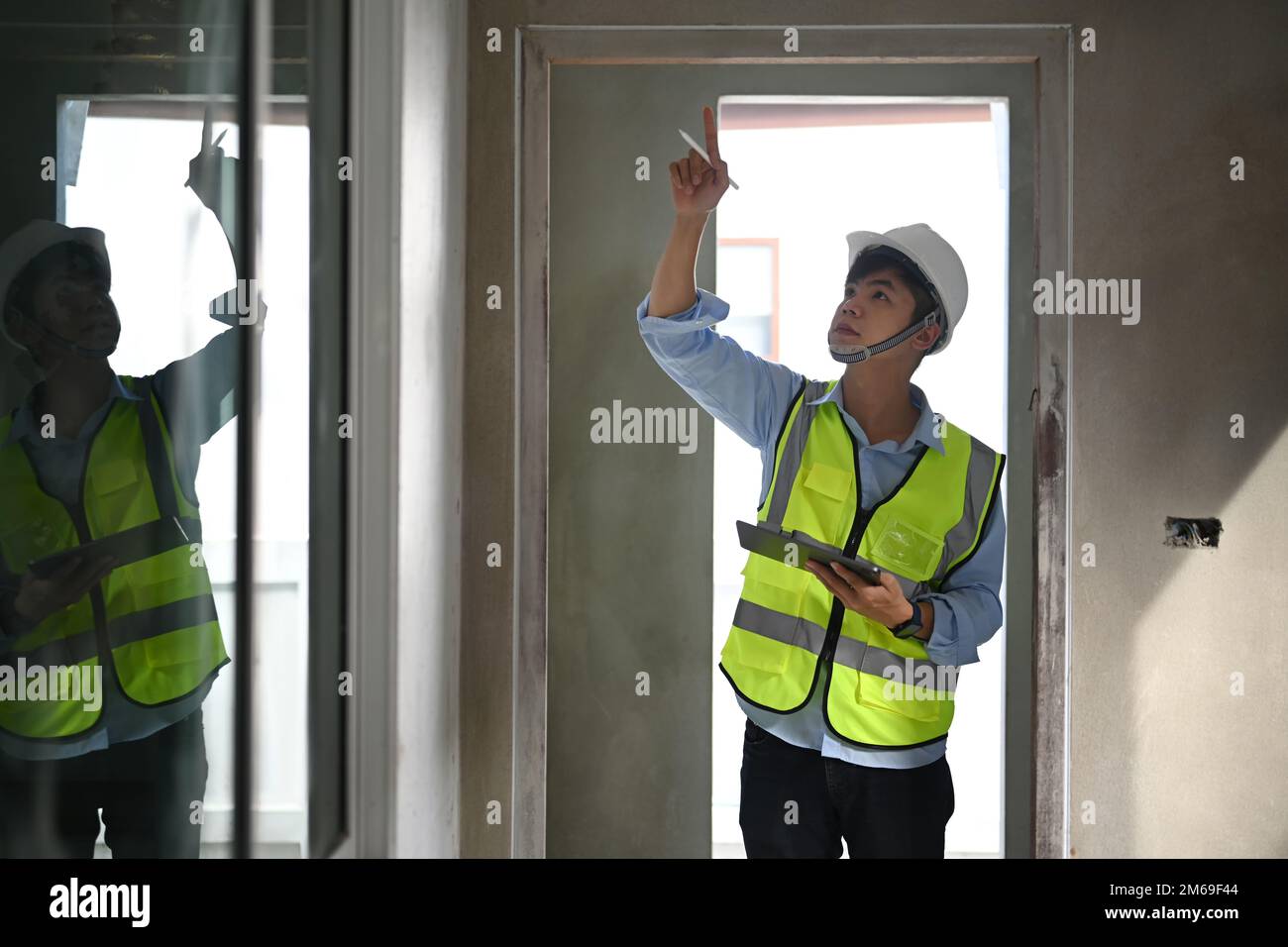 Engineer man with digital tablet checking and inspecting progressing ...