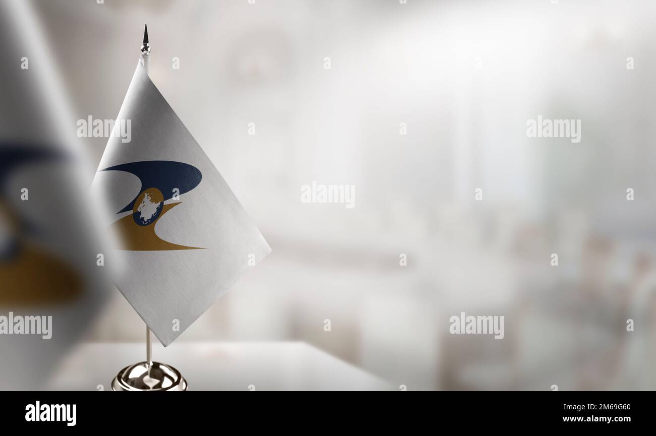 Small flags of the Eurasian Economic Union on an abstract blurry ...