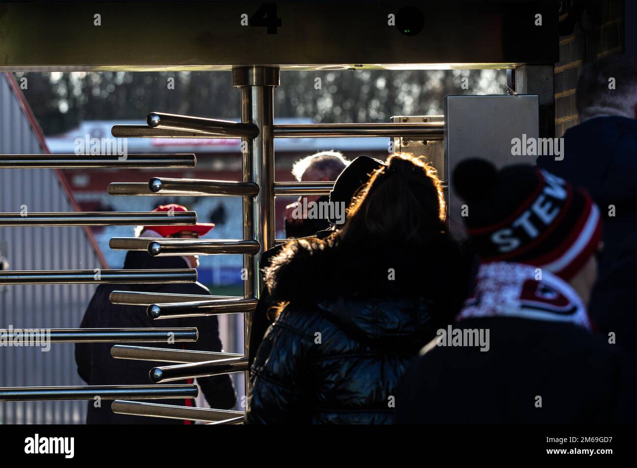 People entering football stadium in UK using turnstile Stock Photo - Alamy
