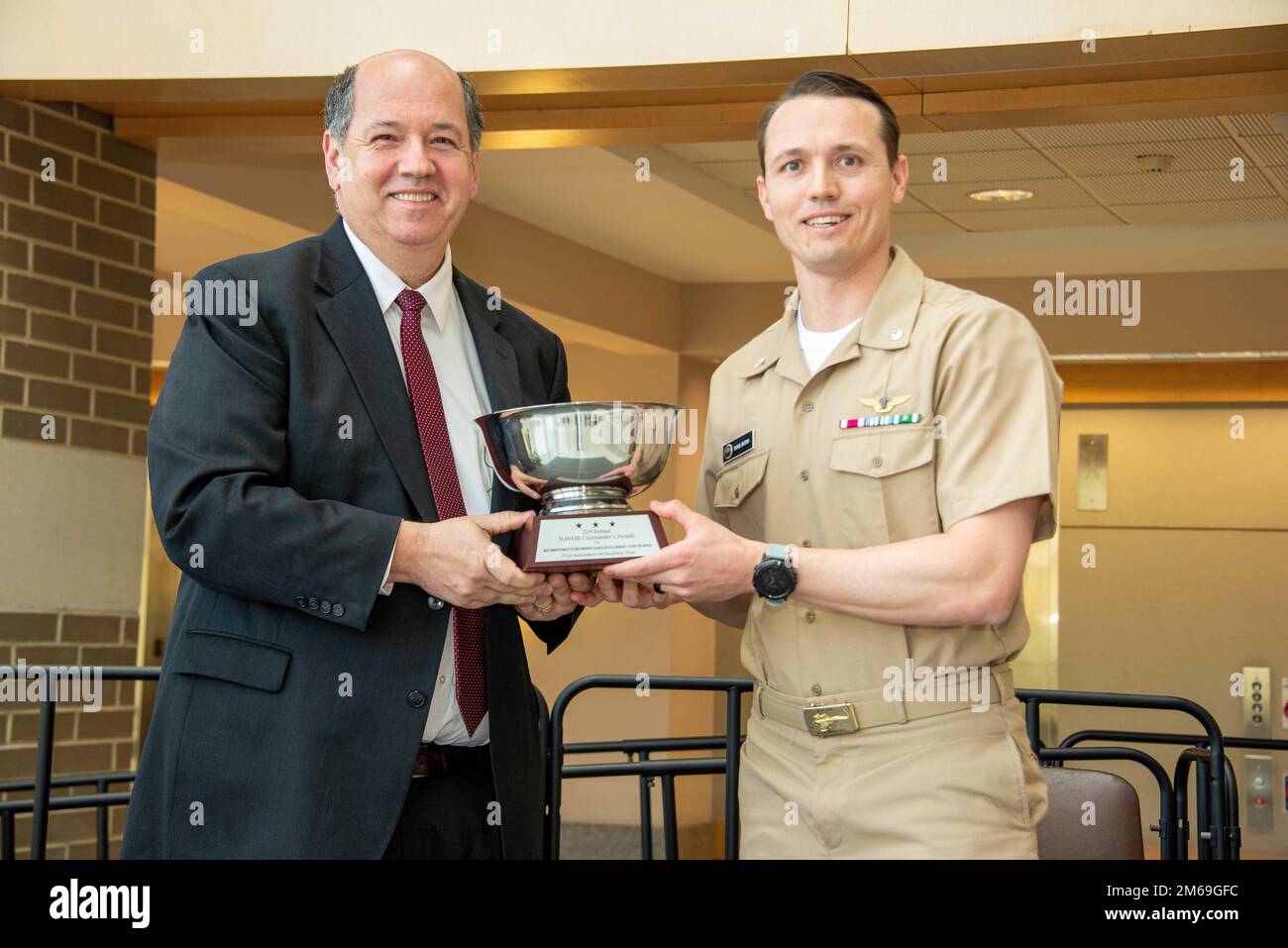 NAVAIR Deputy Commander Tom Rudowsky presents Cmdr. Dan Hutton, PMA-290 ...