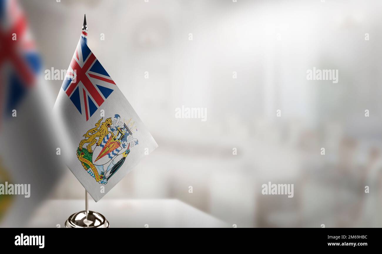Small flags of the British Antarctic Territory on an abstract blurry ...