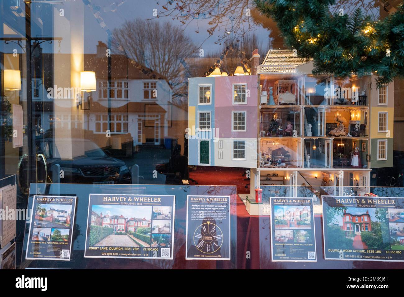 Residential properties and a dolls house are displayed in the window of ...