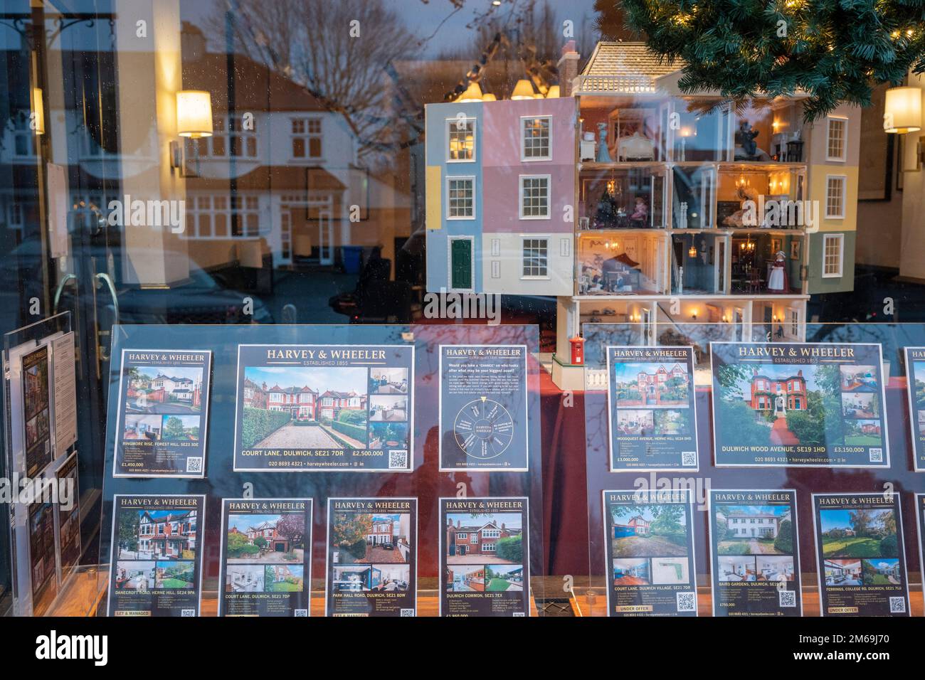 Residential properties and a dolls house are displayed in the window of ...