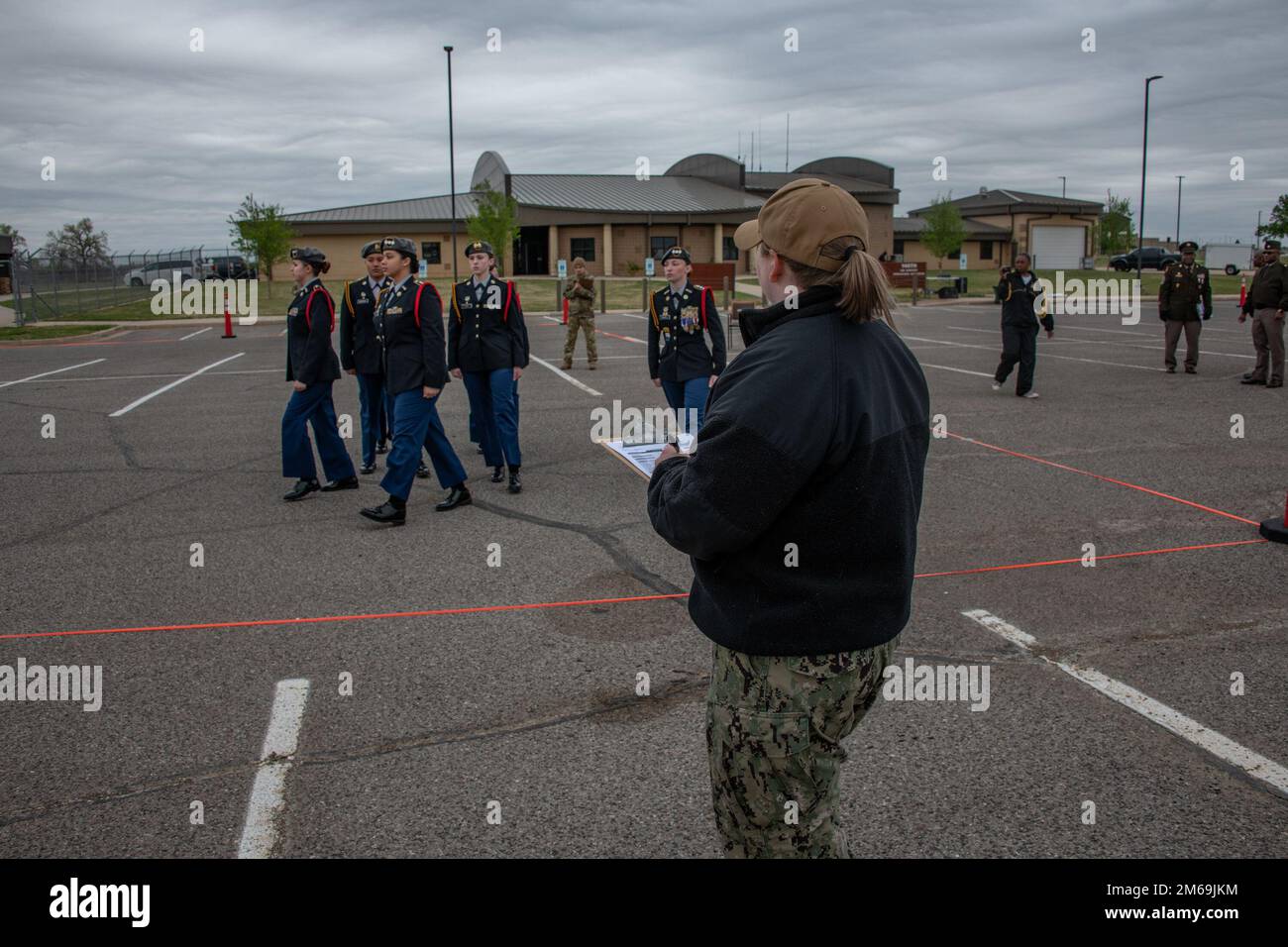 A volunteer judge from the U.S. Navy grades an Army Junior Reserve Officer Training Corps (JROTC ...