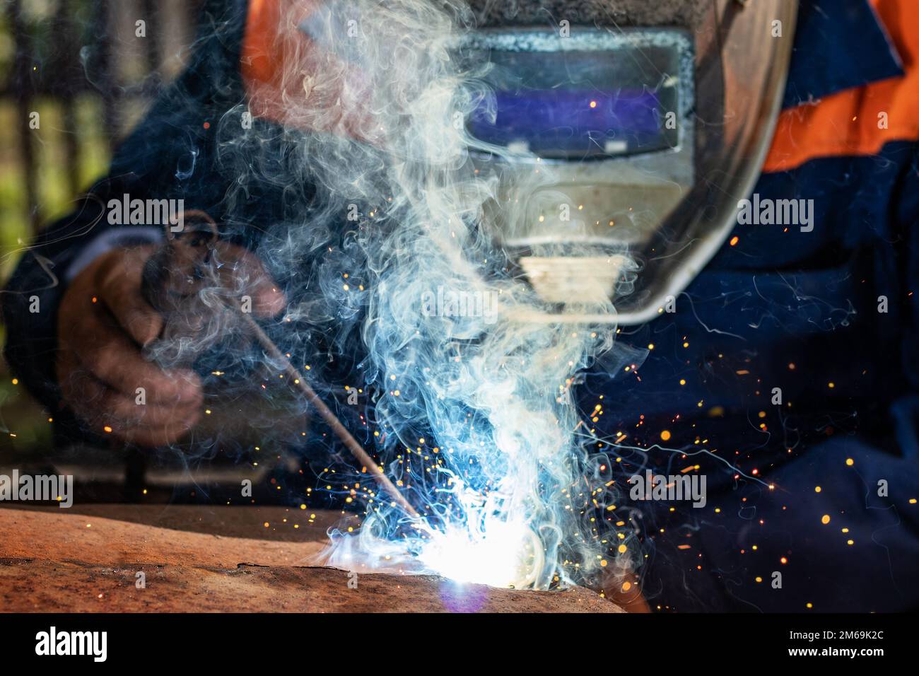Welder erecting technical steel. Industrial steel welder in factory ...