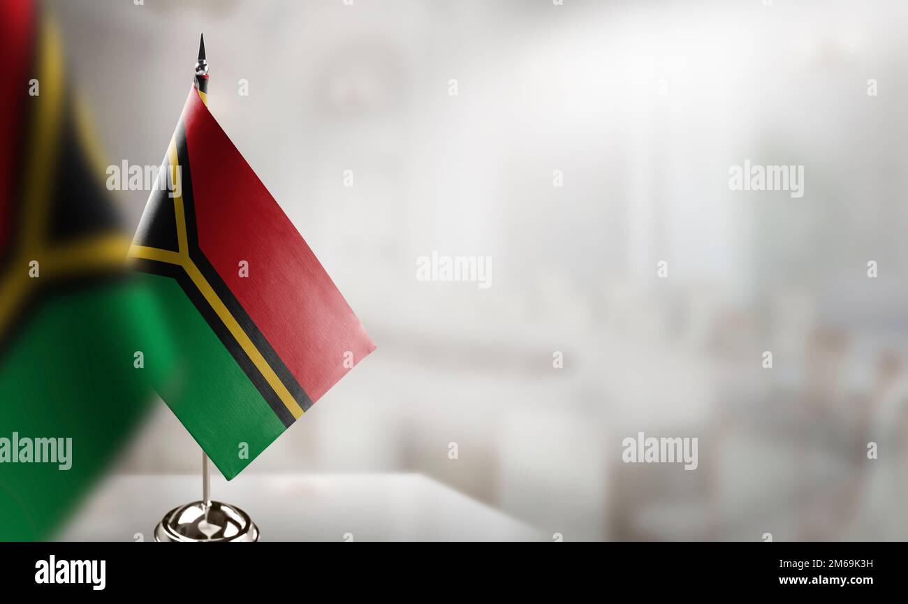 Small flags of the Vanuatu on an abstract blurry background Stock Photo ...