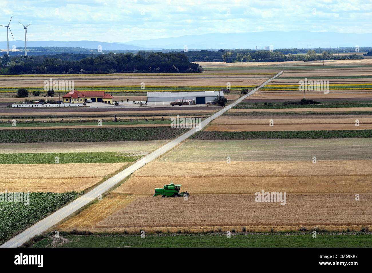 Austria, farm and harvester and aerial view of the flat rural ...